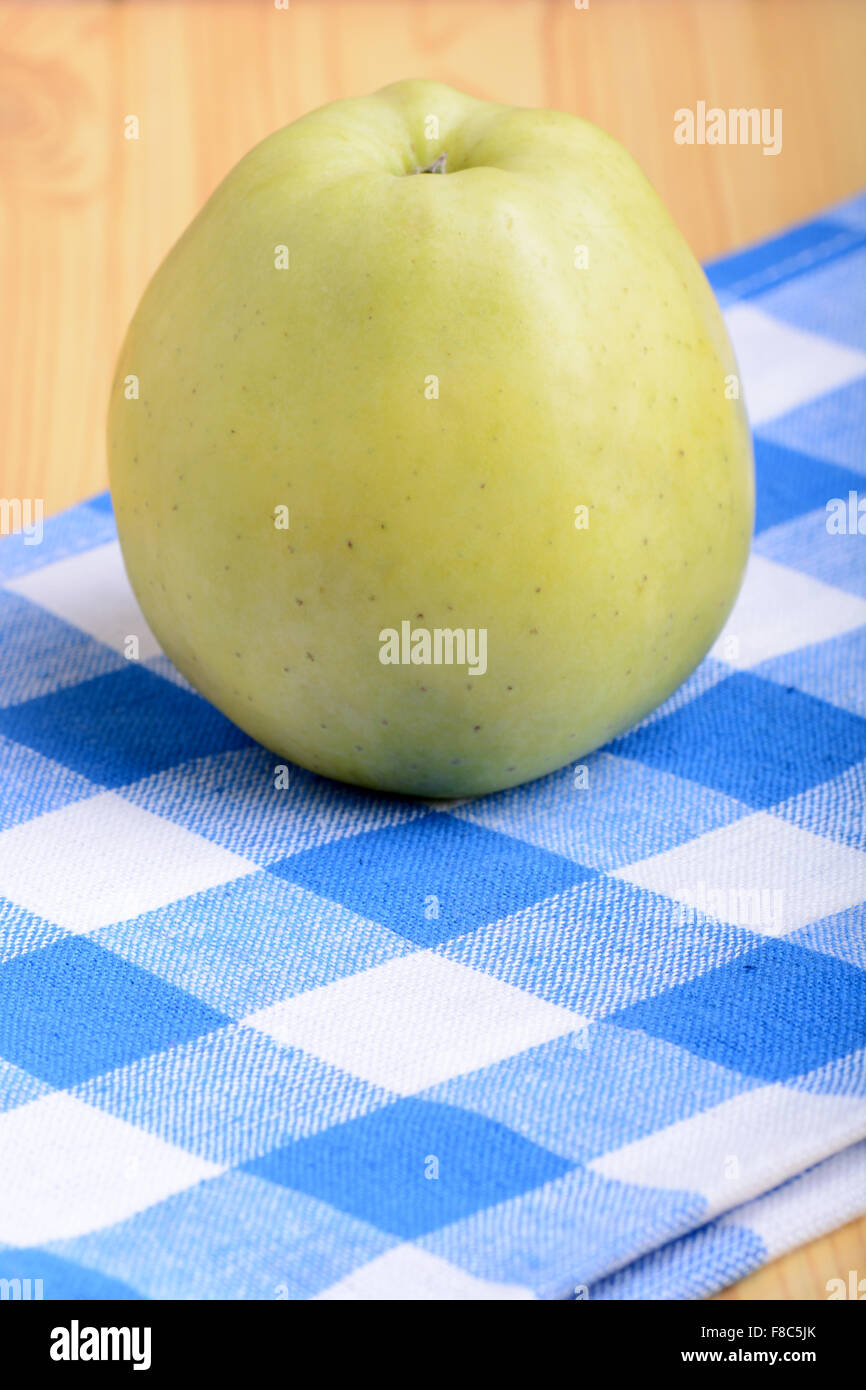 Fresh green apple on blue material backgound Stock Photo - Alamy