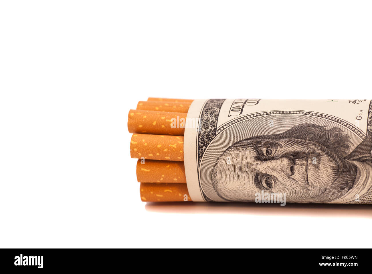 Cigarettes and money on a white background Stock Photo - Alamy