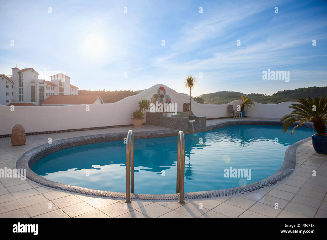 Outdoor swimming pool under a blue sky Stock Photo - Alamy