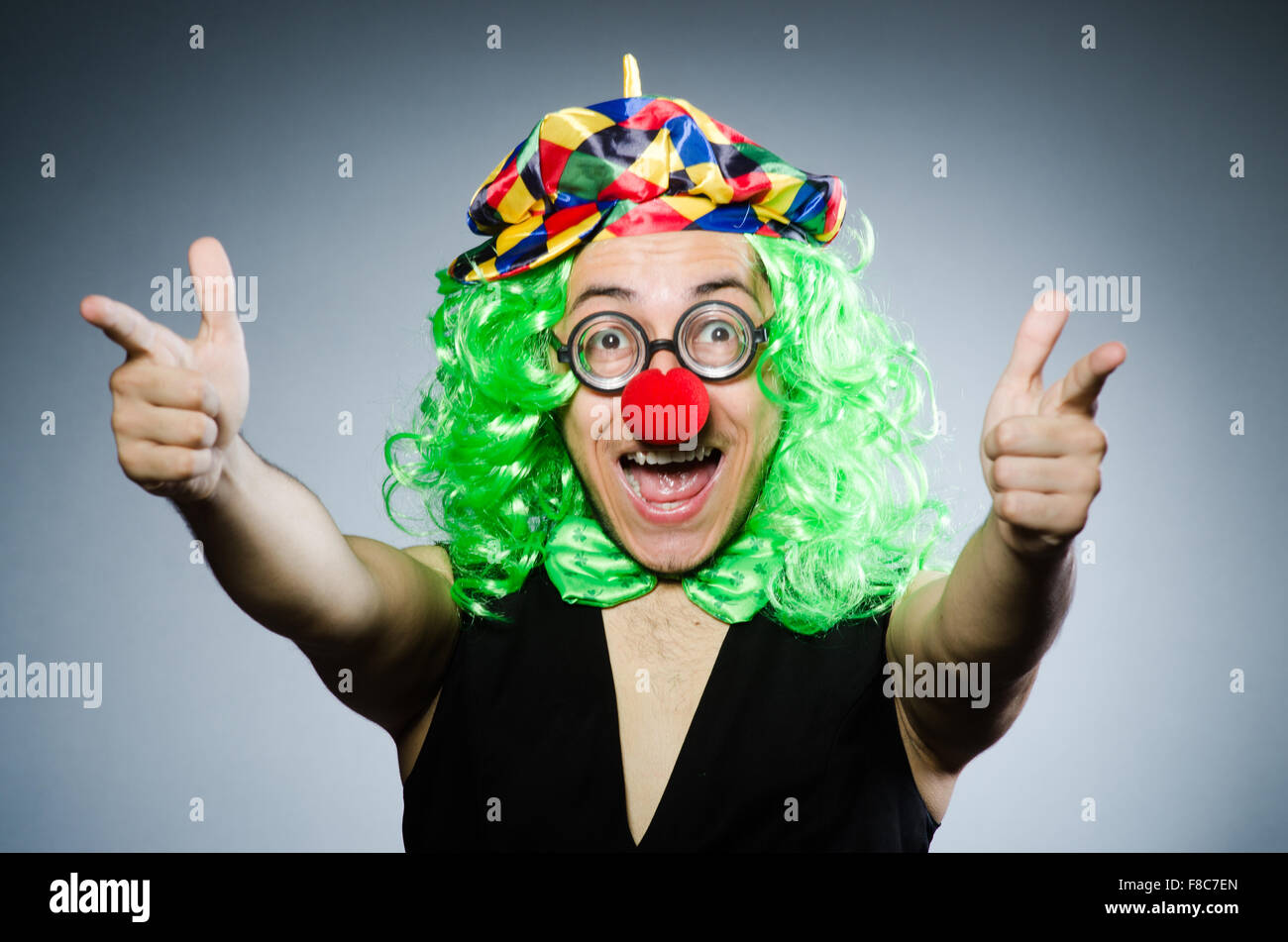 Funny clown against the dark background Stock Photo - Alamy