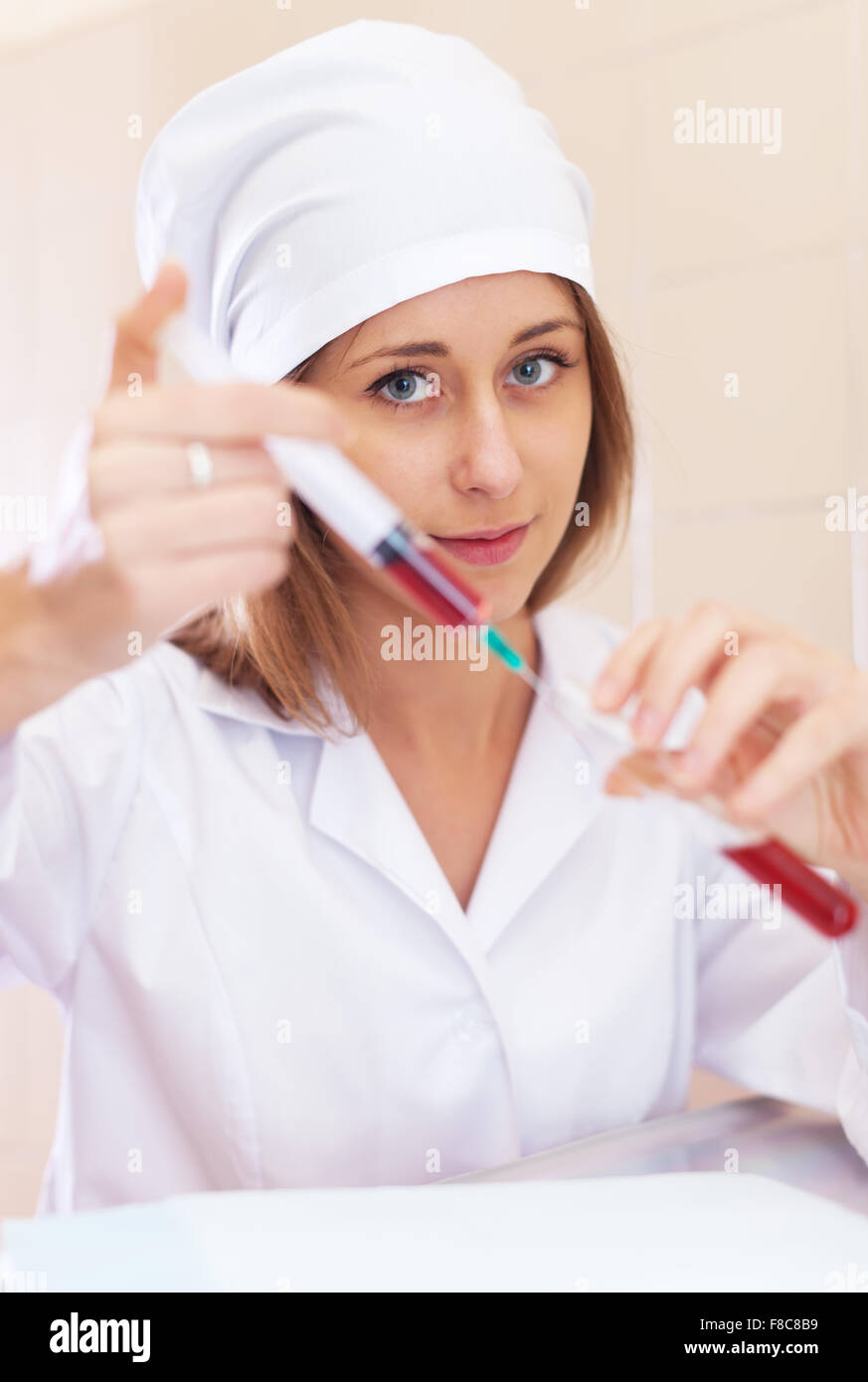 Young nurse works with blood sample in medical laboratory Stock Photo ...