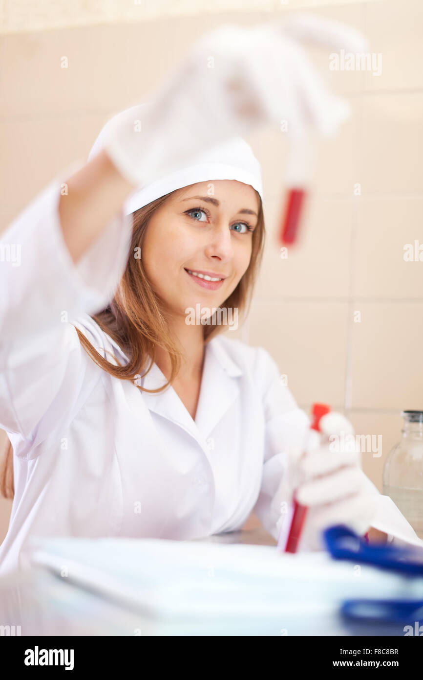 Young nurse works with blood sample in medical laboratory Stock Photo ...