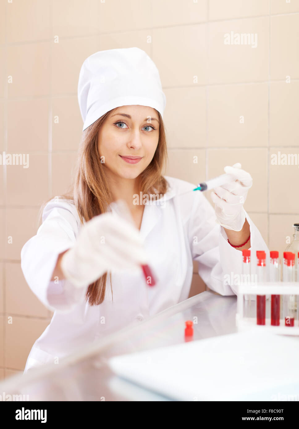 Young nurse works with blood sample in medical laboratory Stock Photo ...