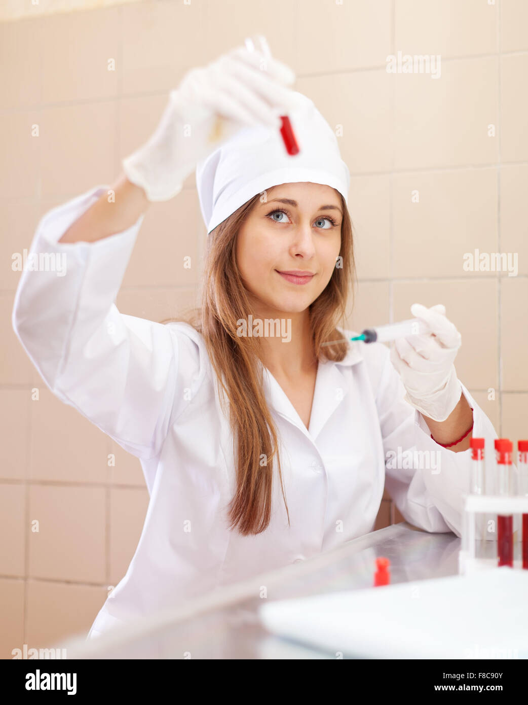 Young nurse works with blood sample in medical laboratory Stock Photo ...