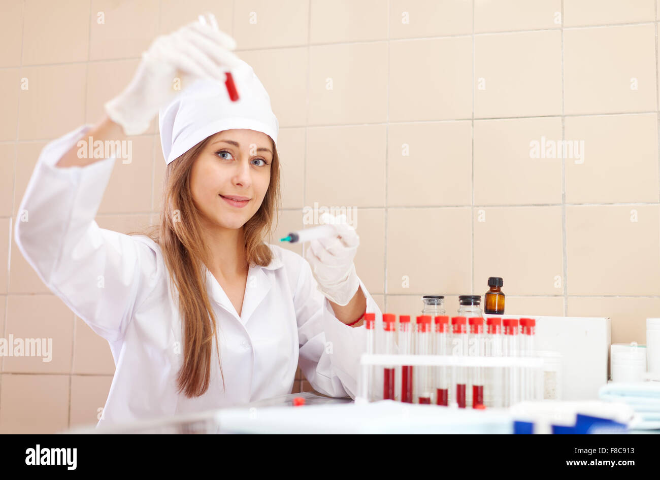 Young nurse works with blood sample in medical laboratory Stock Photo ...
