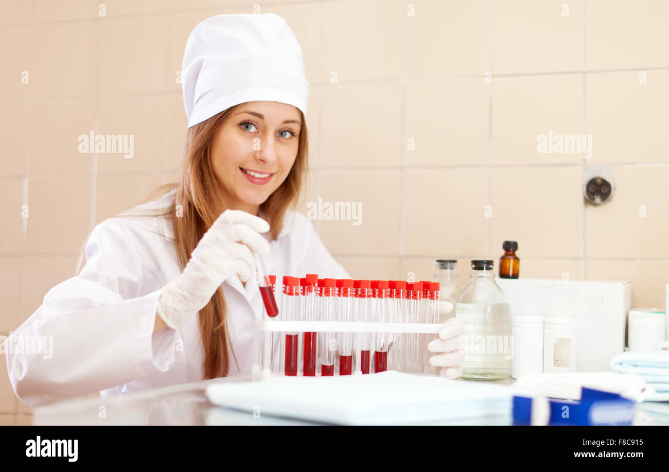 Young nurse works with blood sample in medical laboratory Stock Photo ...