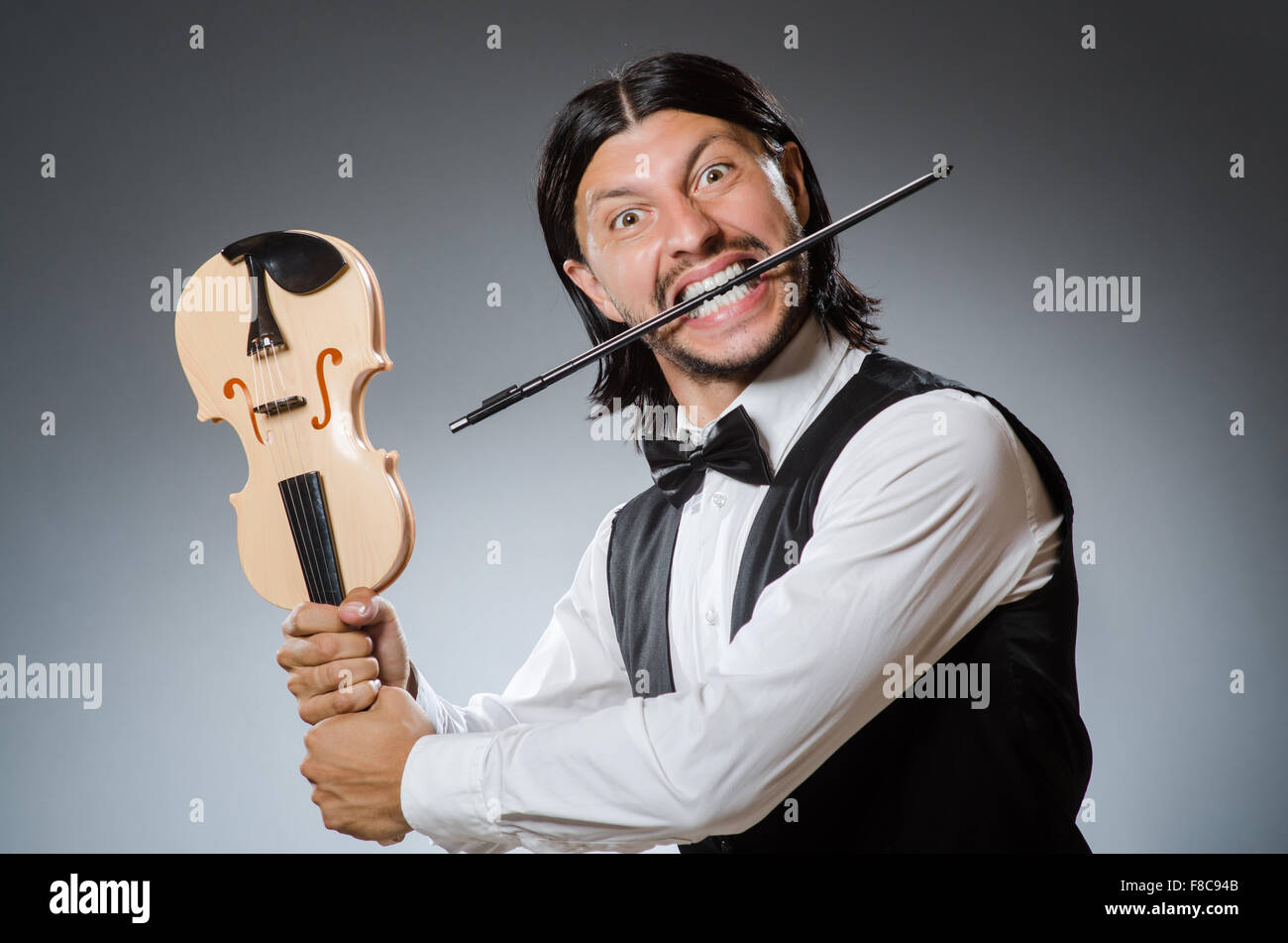 Funny fiddle violin player in musical concept Stock Photo - Alamy