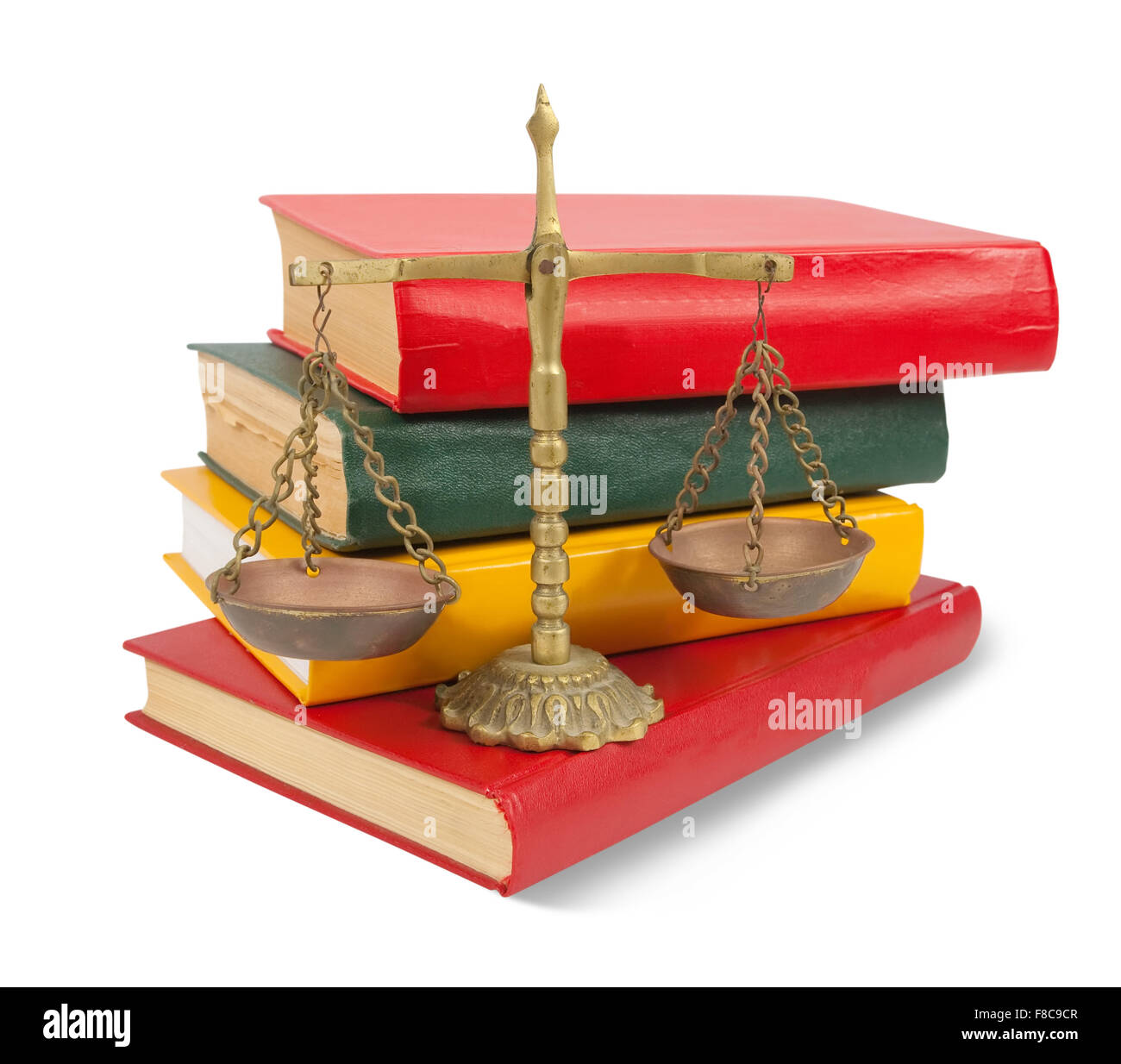 Scales of justice atop legal books. Isolated with clipping path over ...