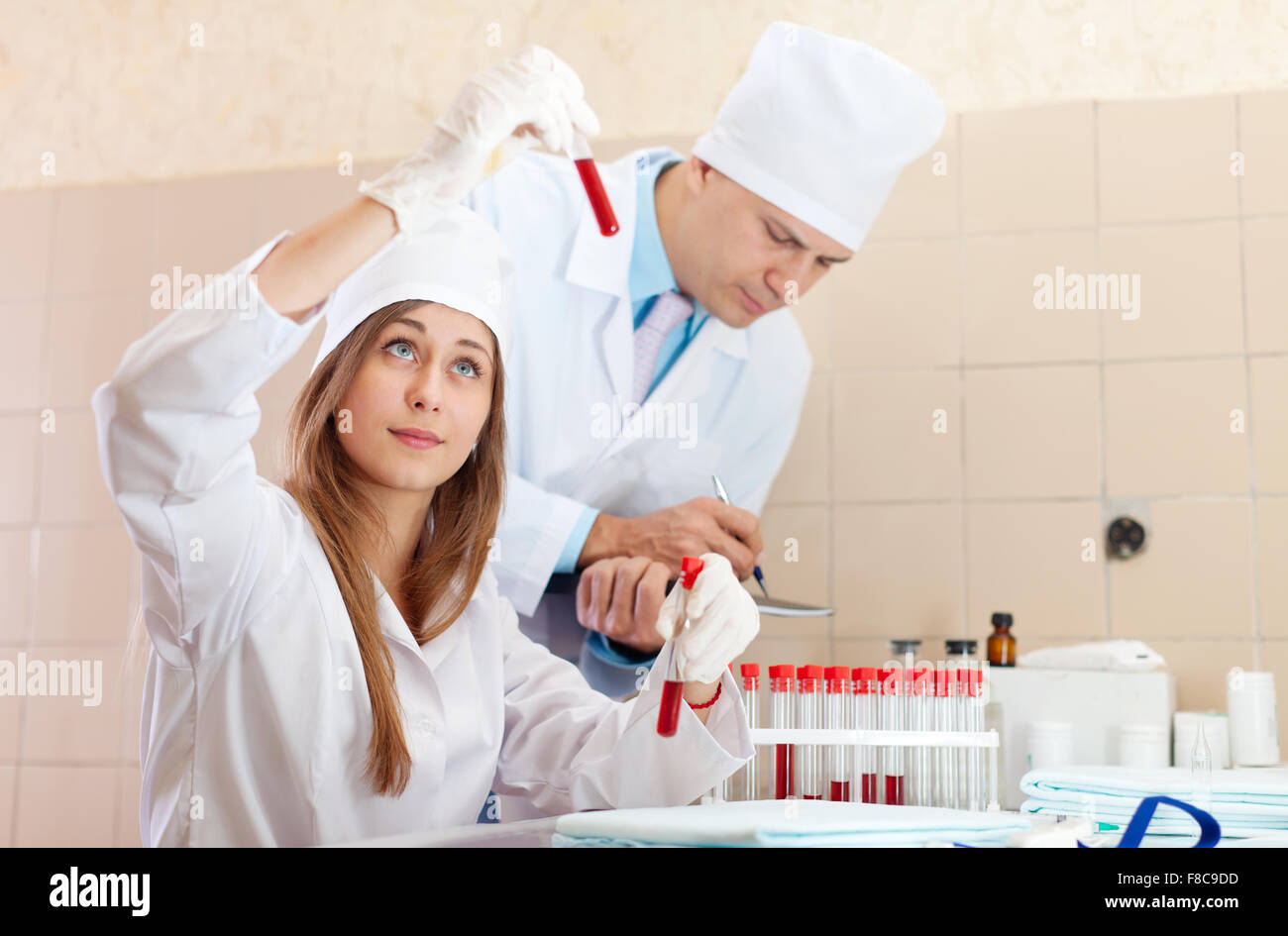 nurse and male doctor works with test tubes in clinic lab Stock Photo ...