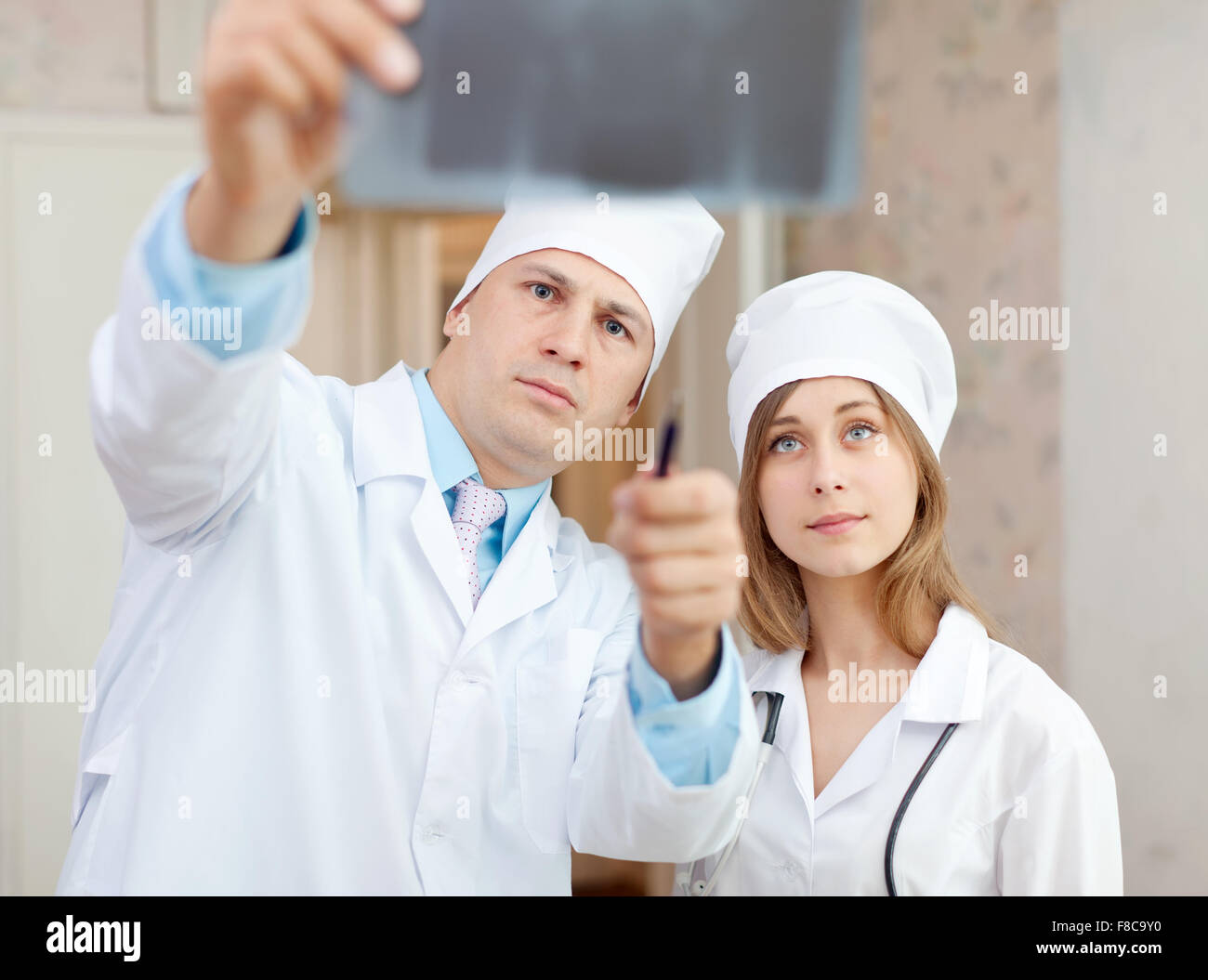 serious doctors stares x-ray scan in clinic Stock Photo - Alamy