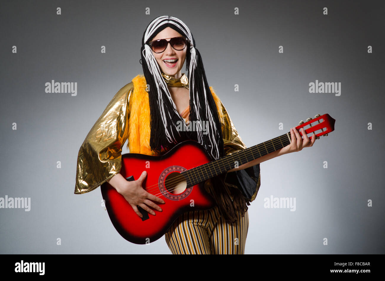 Guitar player with red instrument Stock Photo - Alamy