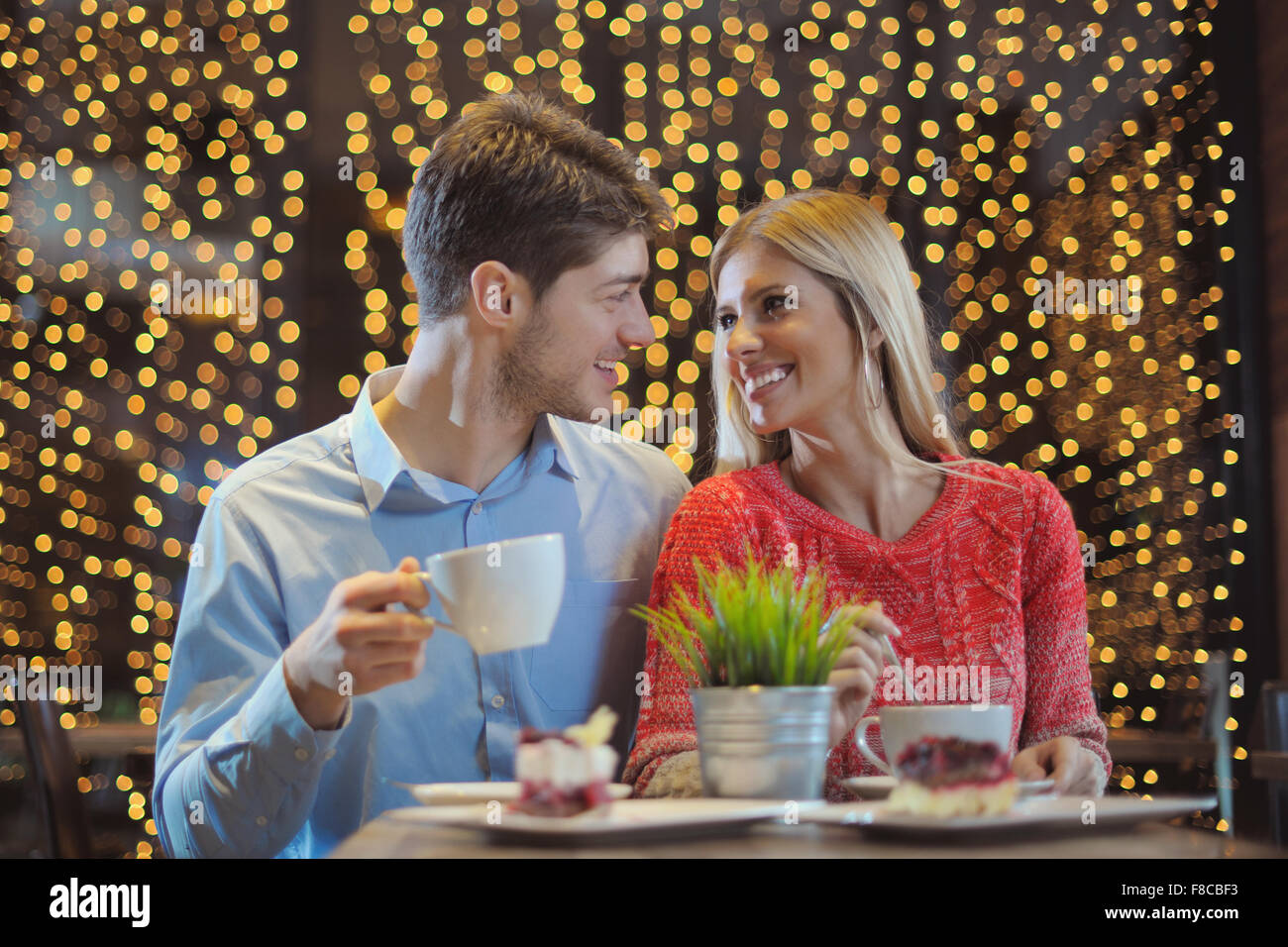romantic evening date in restaurant happy young couple with wine glass ...