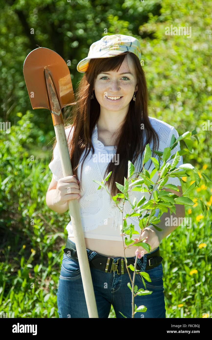 Young woman setting tree outdoor in spring Stock Photo - Alamy