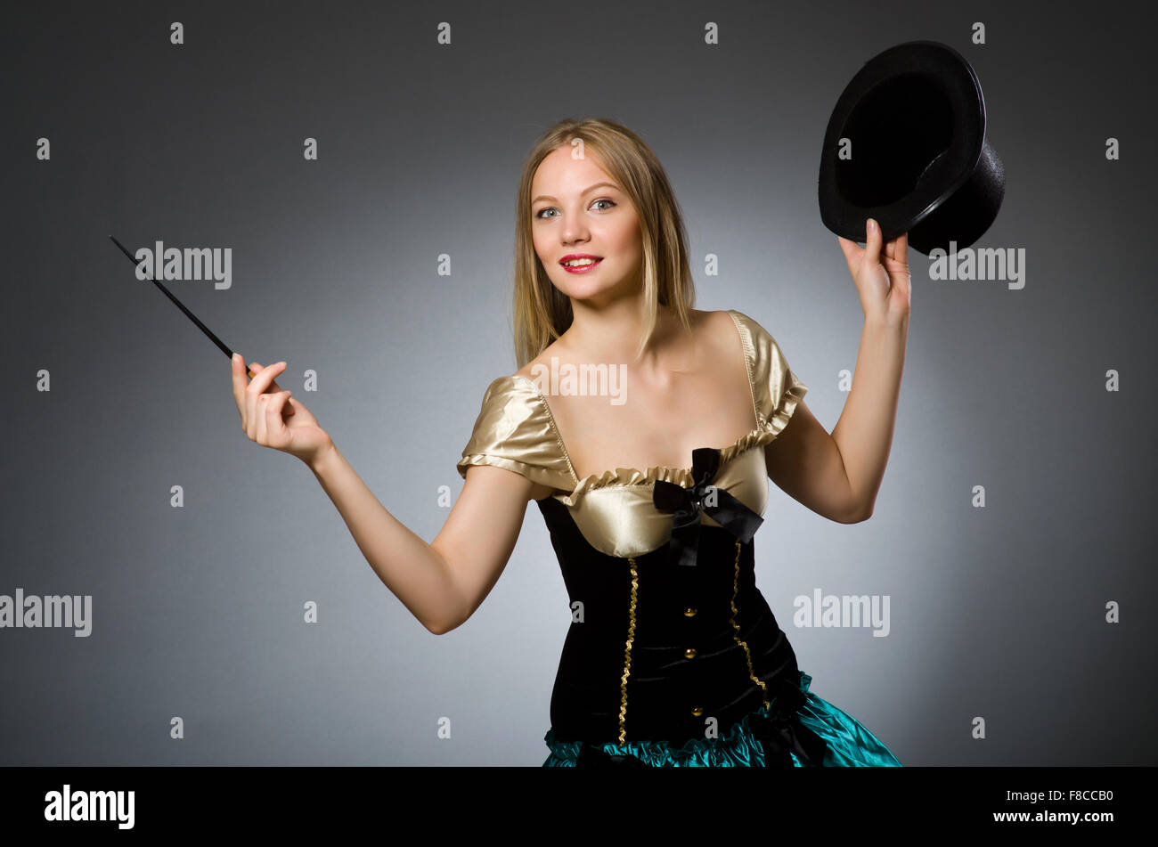 Woman magician with magic wand and hat Stock Photo - Alamy