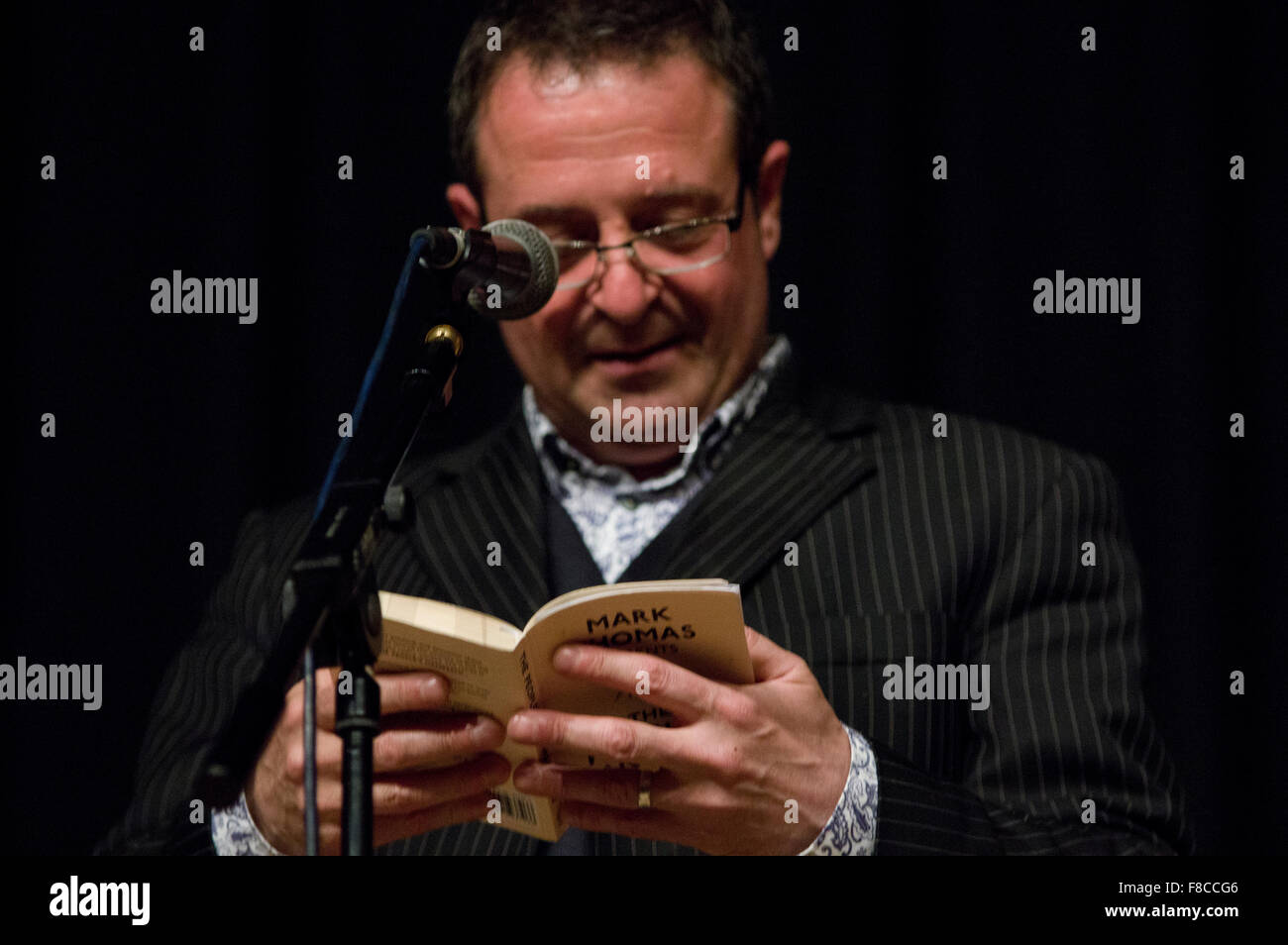Comedian Mark Thomas reading from his book The People's Manifesto in ...