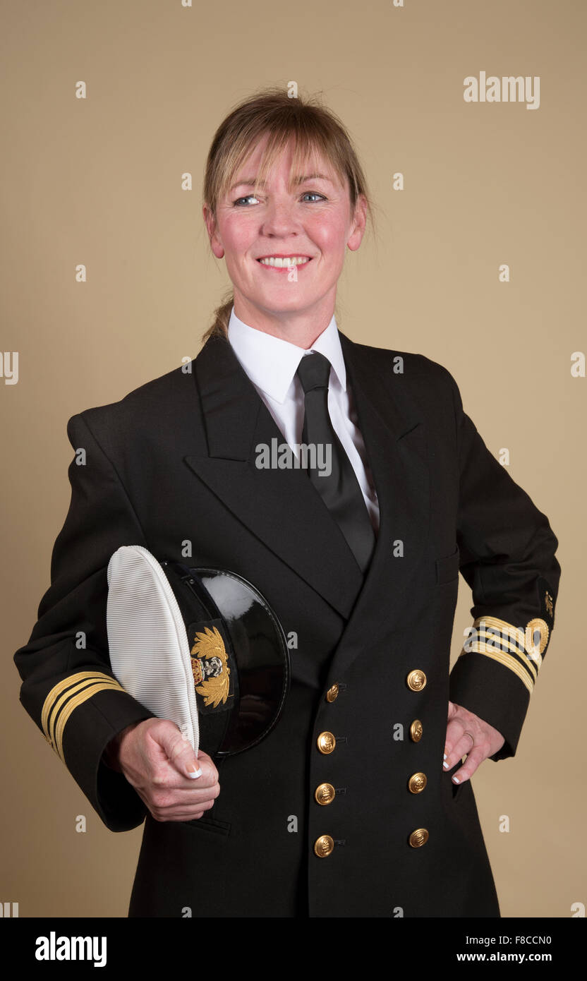 Portrait of a woman Lt Commander in uniform and holding her hat under ...
