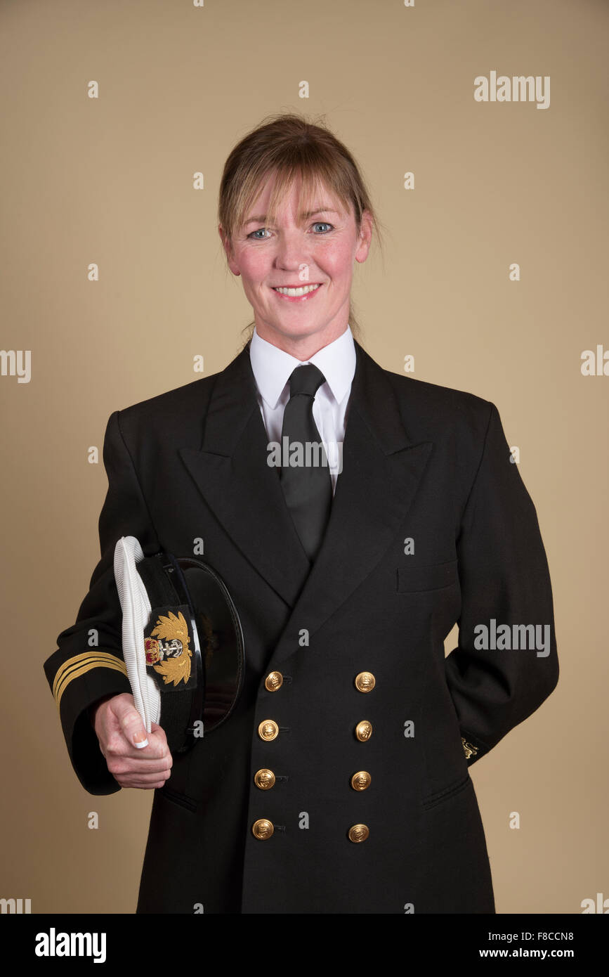 Portrait of a woman Lt Commander in uniform and holding her hat under ...