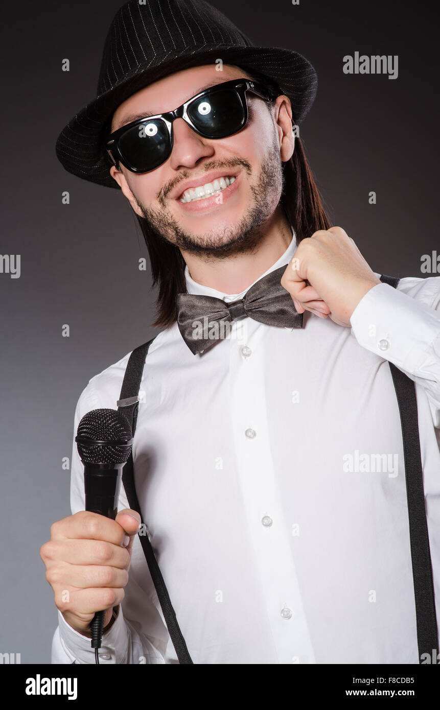 Funny singer with microphone at the concert Stock Photo - Alamy