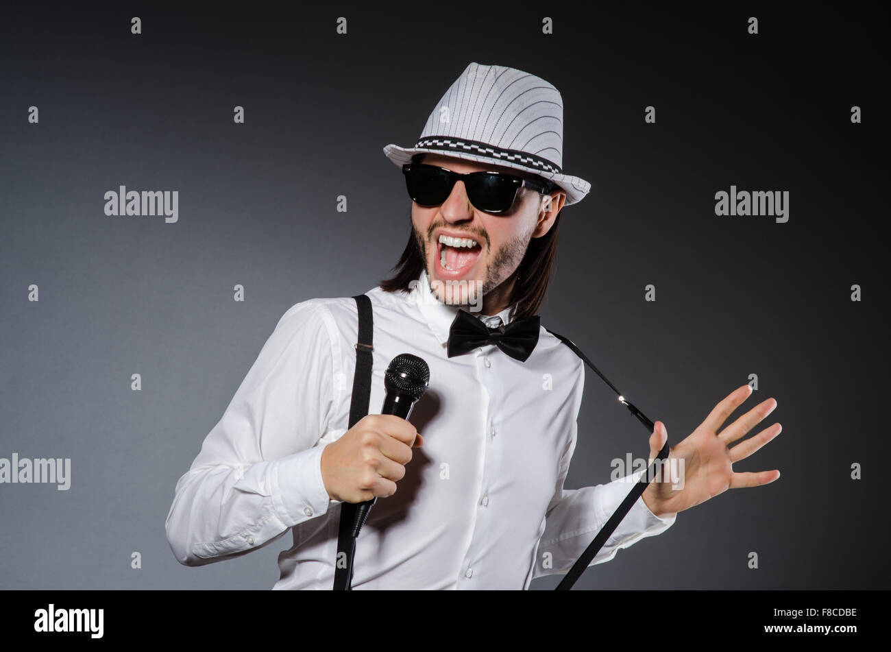 Funny singer with microphone at the concert Stock Photo - Alamy