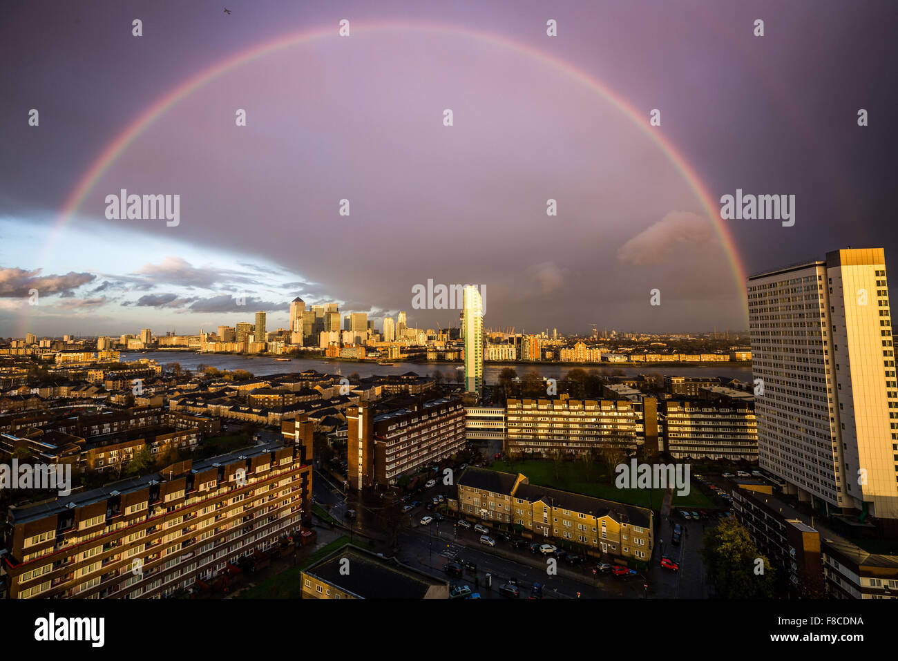 London, UK. 8th December, 2015. UK Weather: Massive rainbow breaks over ...