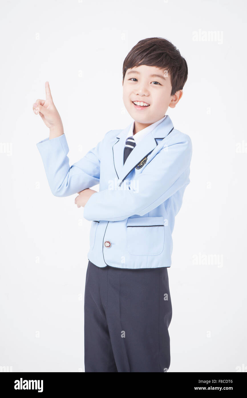 Elementary school boy in school uniforms staring forward with a smile ...