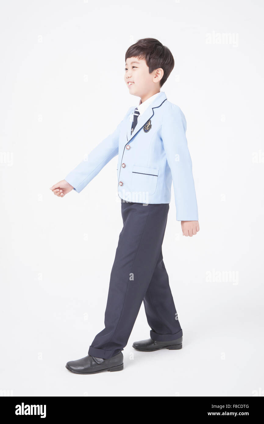 Elementary school boy in school uniforms walking with a smile Stock ...