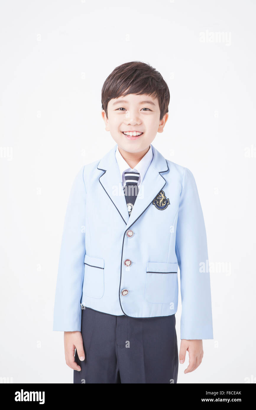Elementary school boy in school uniforms staring forward with a smile ...
