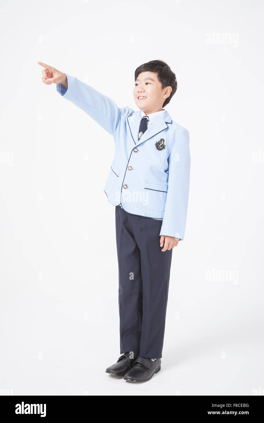 Elementary school boy in school uniforms standing with a smile and ...