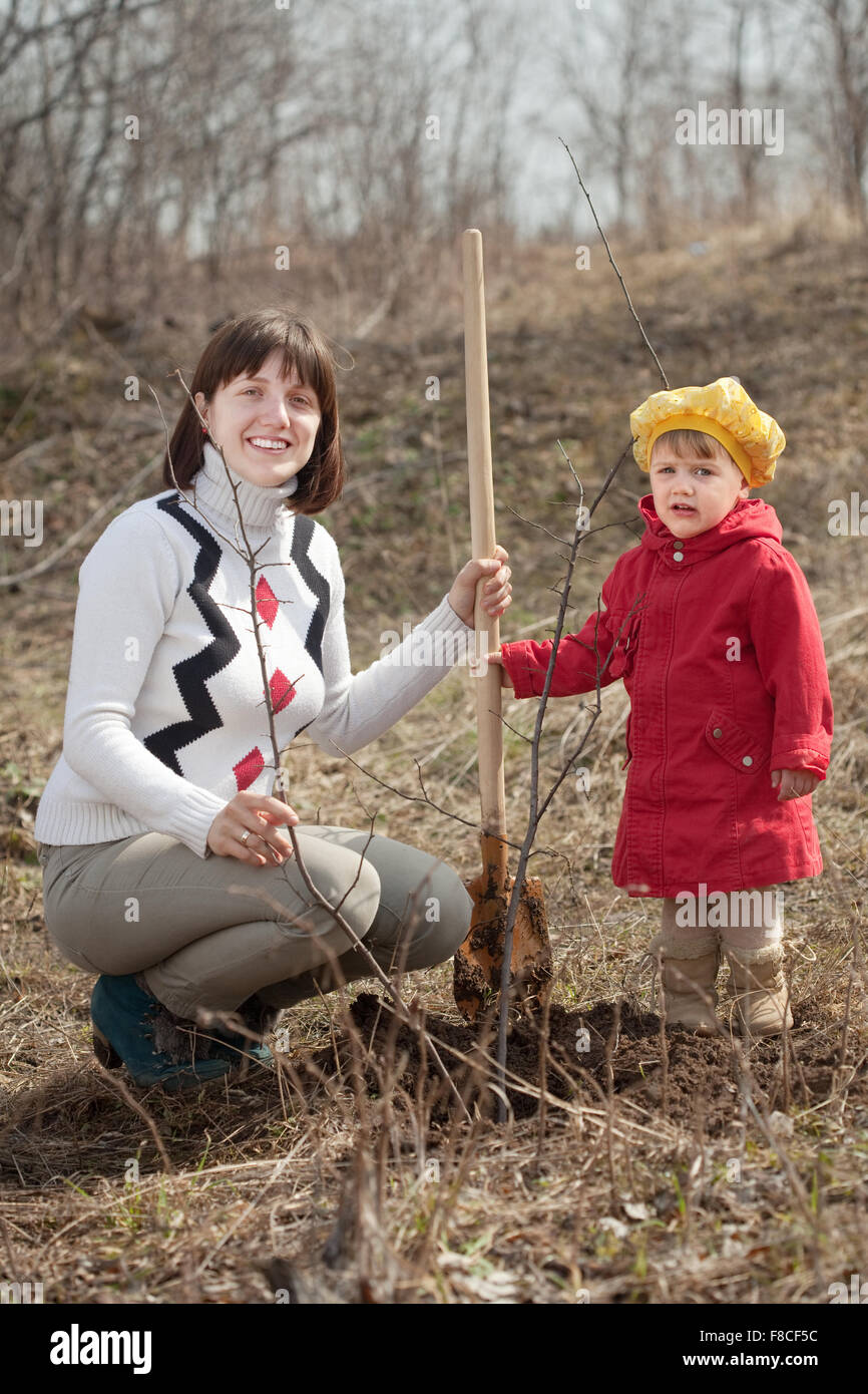 Mother and her baby girl planting tree Stock Photo - Alamy