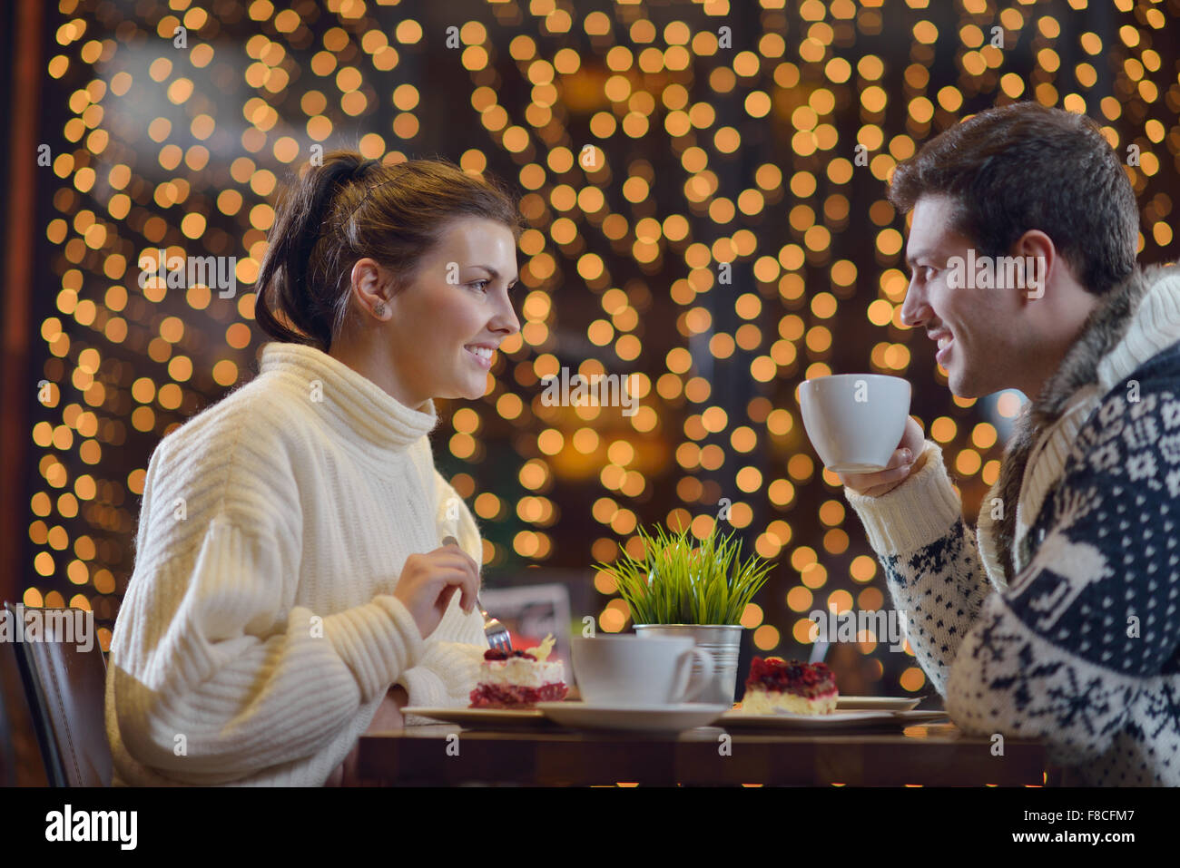romantic evening date in restaurant happy young couple with wine glass ...