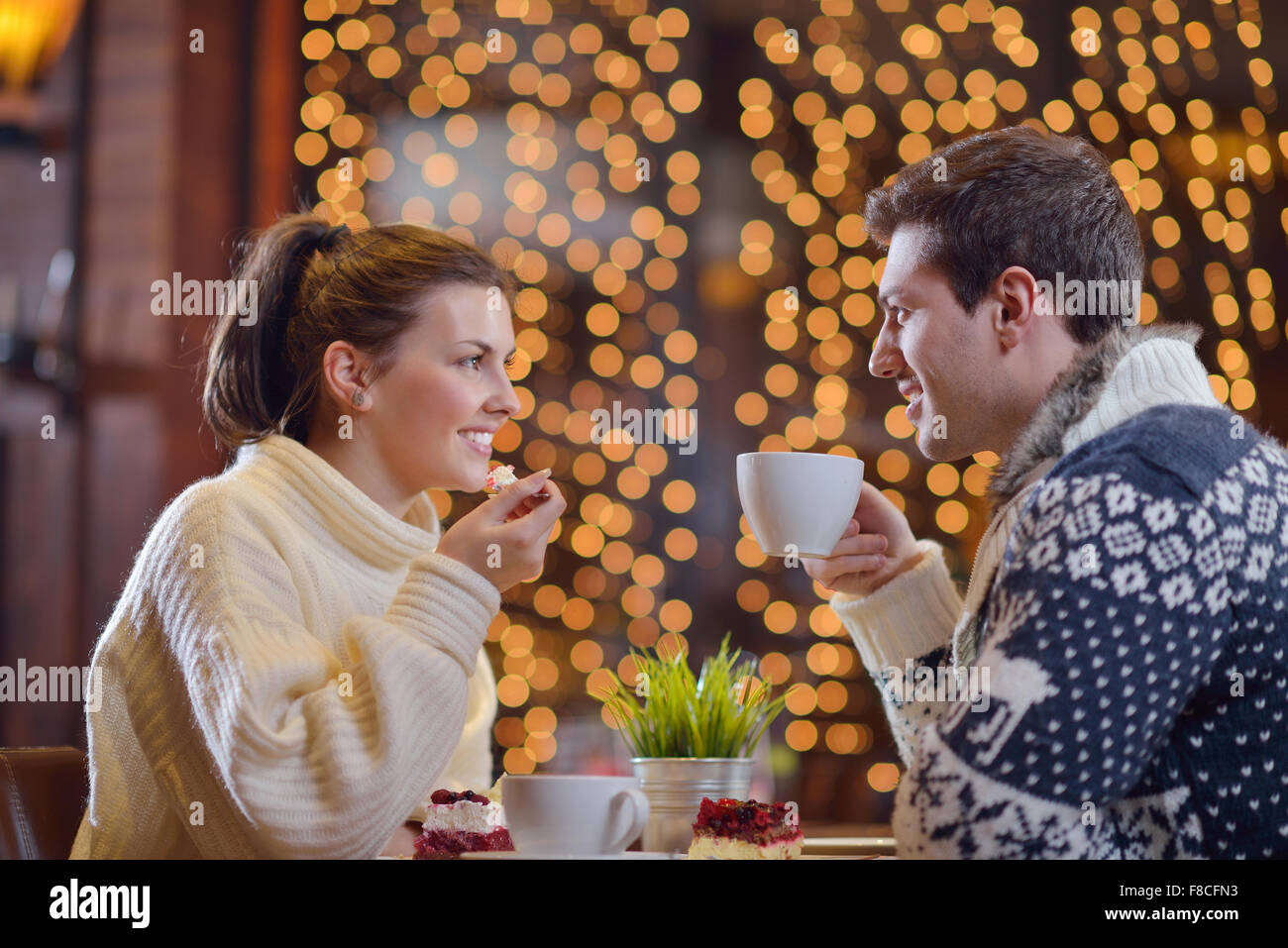 romantic evening date in restaurant happy young couple with wine glass ...