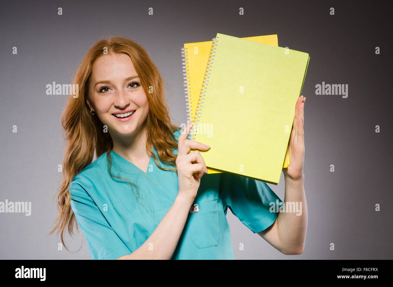 Young woman doctor with book Stock Photo - Alamy