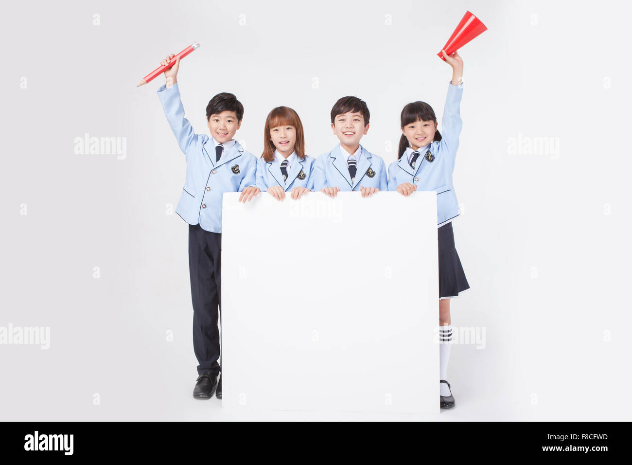 White copy space on the floor and four elementary school students ...