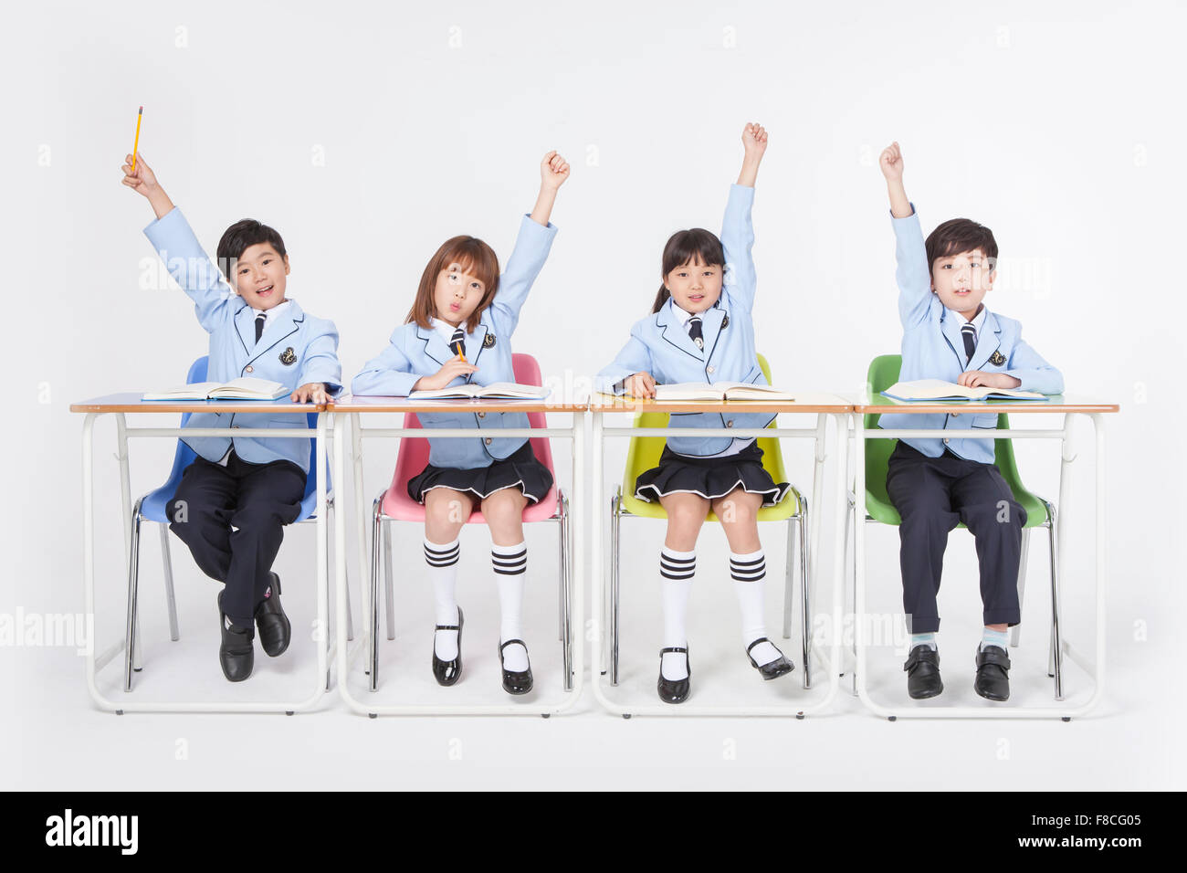 Child putting hand up in class hi-res stock photography and images - Alamy