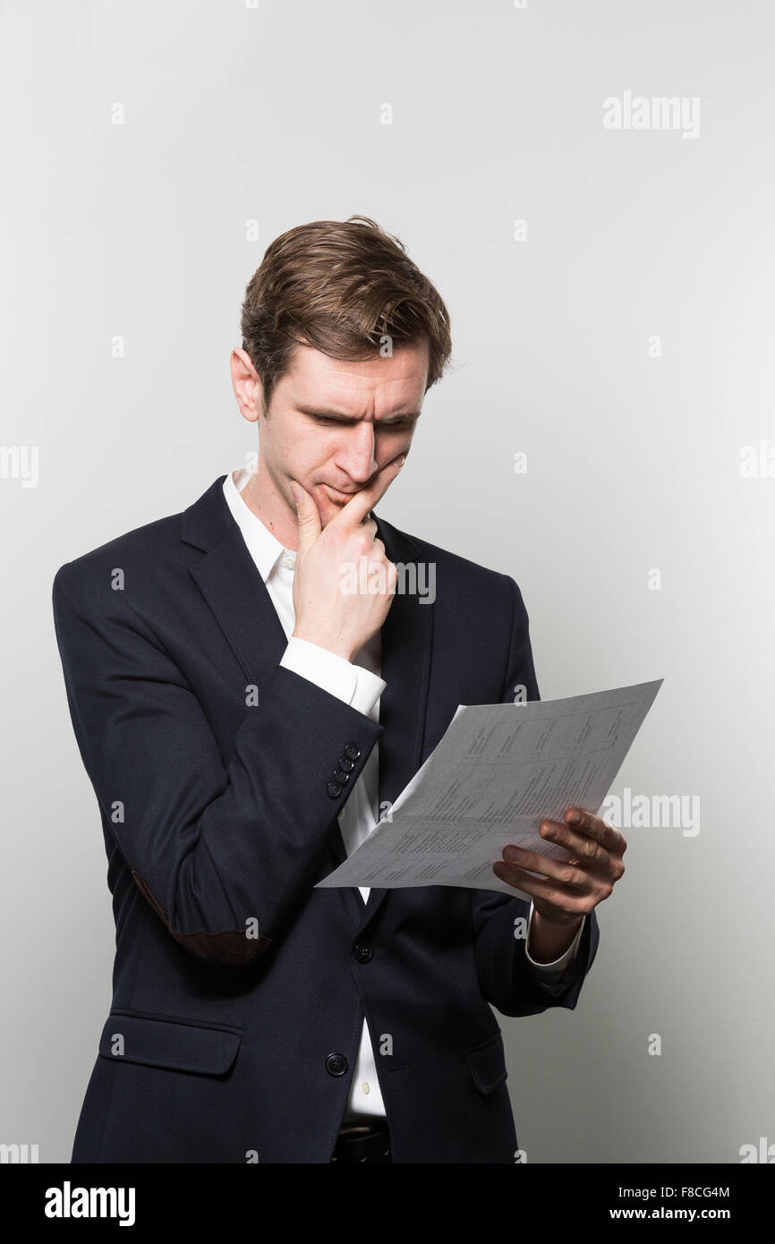 Blond-haired european businessman with a contemplative look stares on a ...