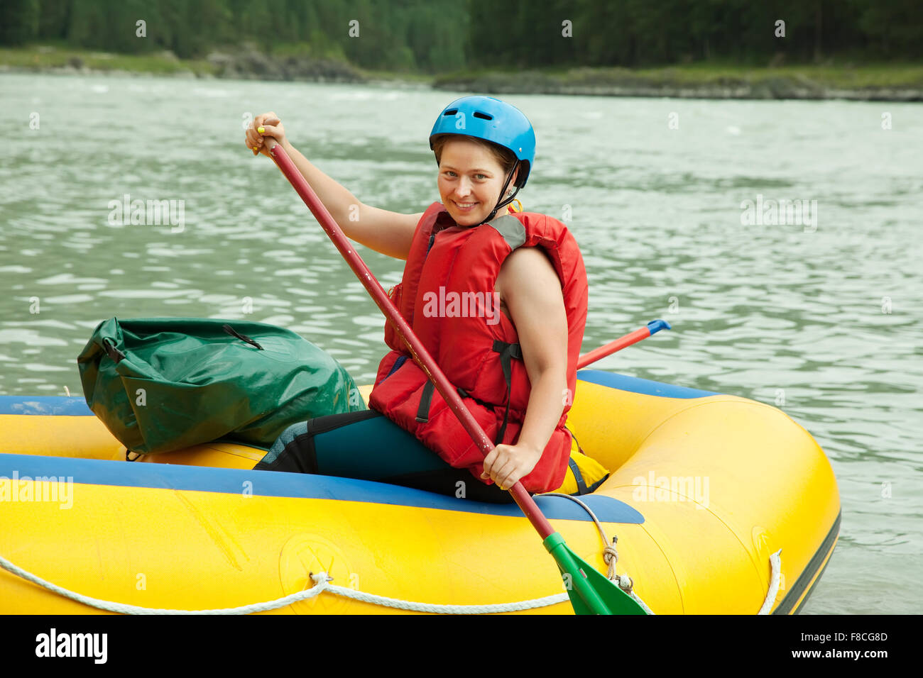 Girl with a paddle on the raft Stock Photo - Alamy