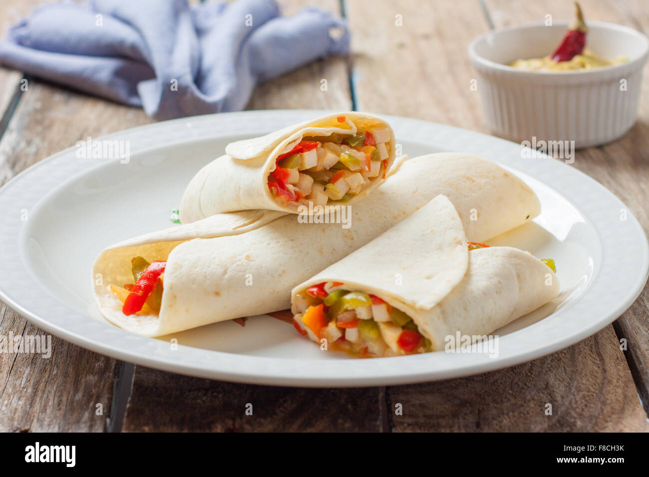 mexican style wrap filled with chicken and vegetables Stock Photo - Alamy