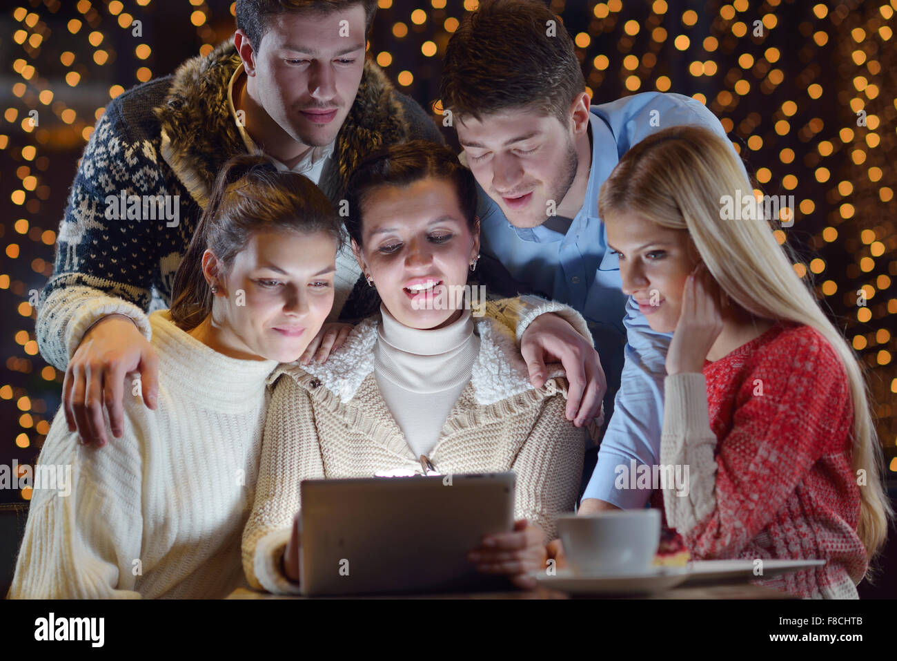 Group of happy people looking at a tablet computer Stock Photo - Alamy
