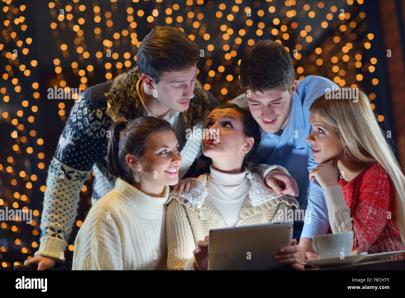 Group of happy people looking at a tablet computer Stock Photo - Alamy