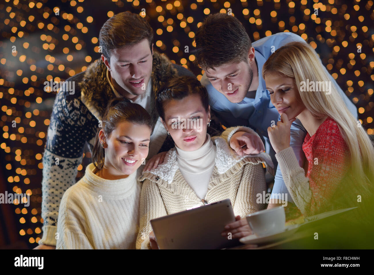 Group of happy people looking at a tablet computer Stock Photo - Alamy