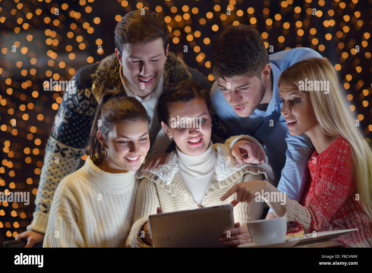 Group of happy people looking at a tablet computer Stock Photo - Alamy