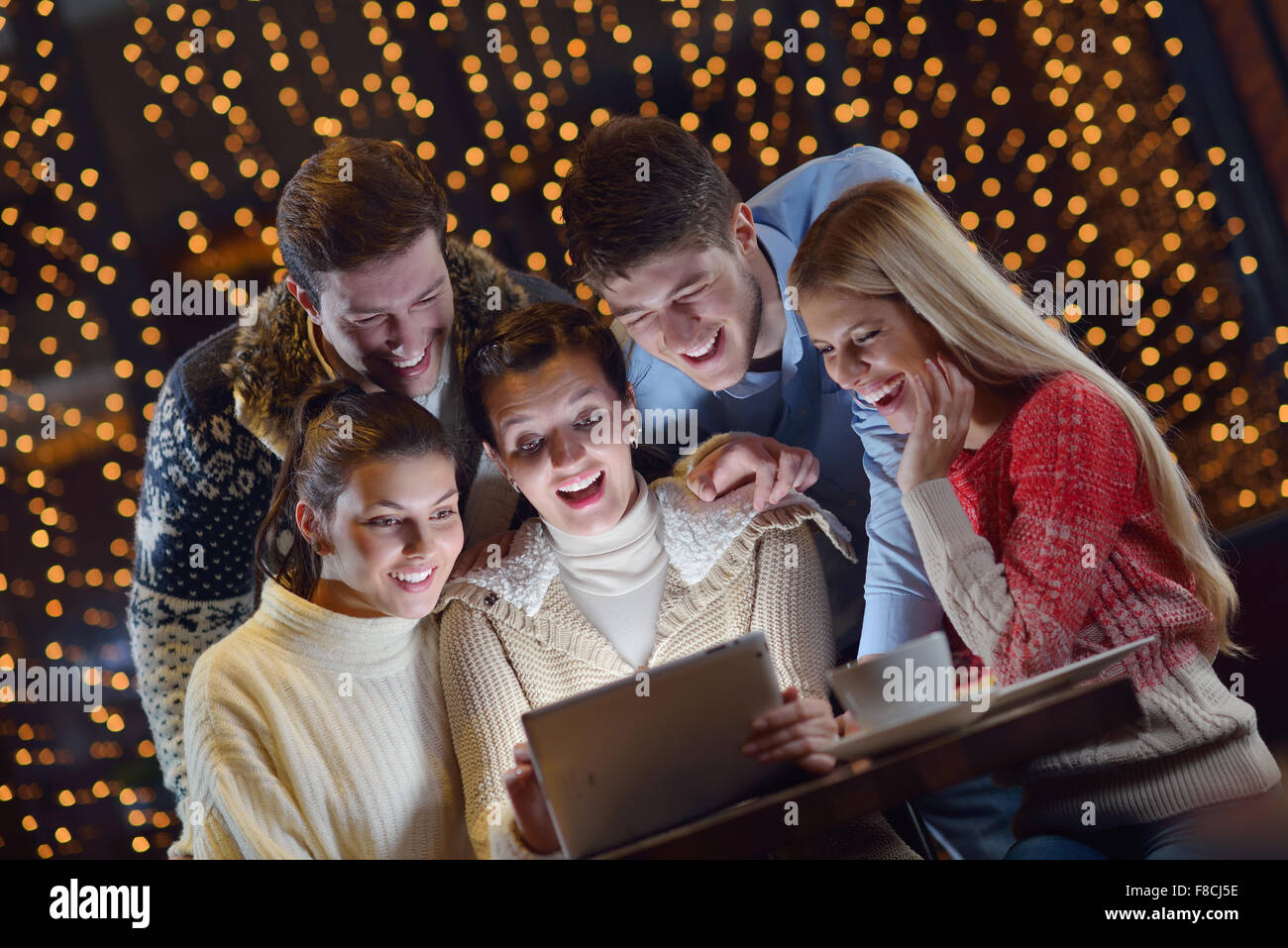 Group of happy people looking at a tablet computer Stock Photo - Alamy