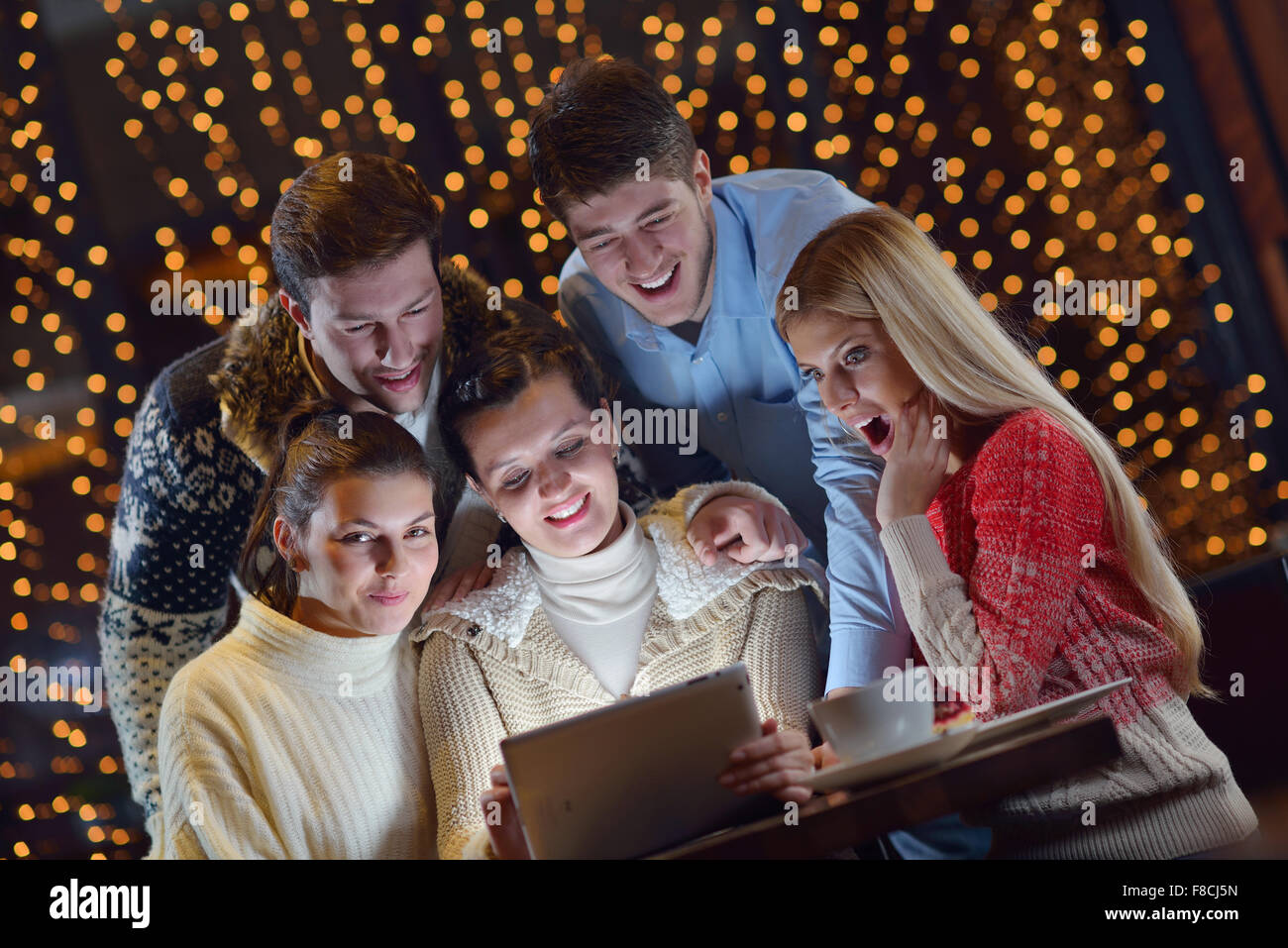 Group of happy people looking at a tablet computer Stock Photo - Alamy