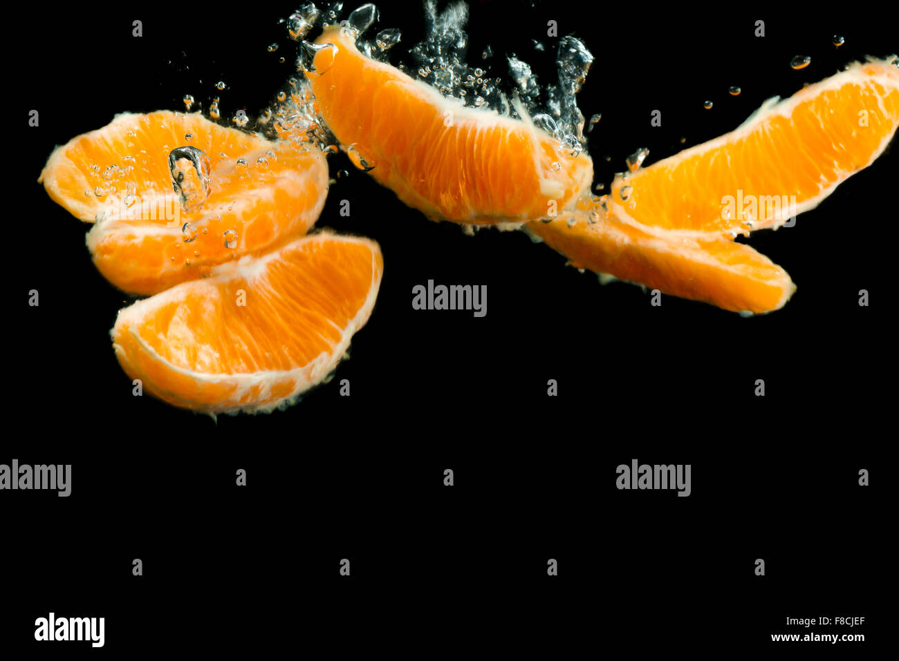 orange falling into water Stock Photo - Alamy