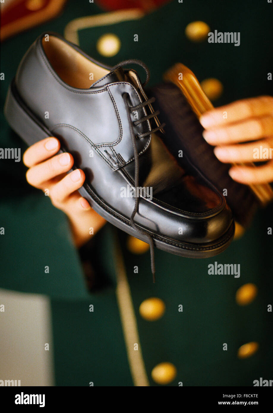 bellboy,cleaning shoes of a guest Stock Photo - Alamy