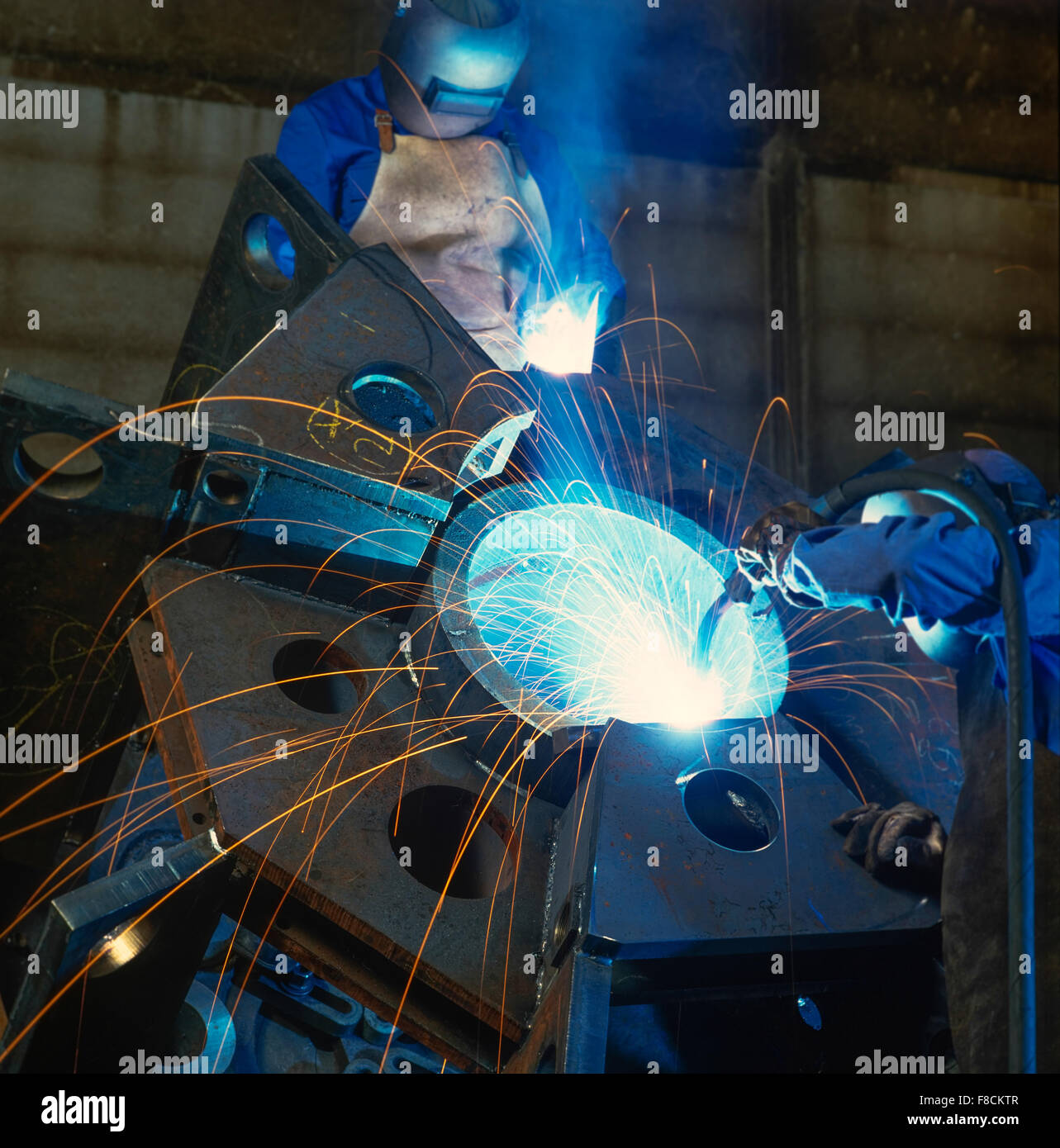welding specialists welding a big piece of metal Stock Photo - Alamy