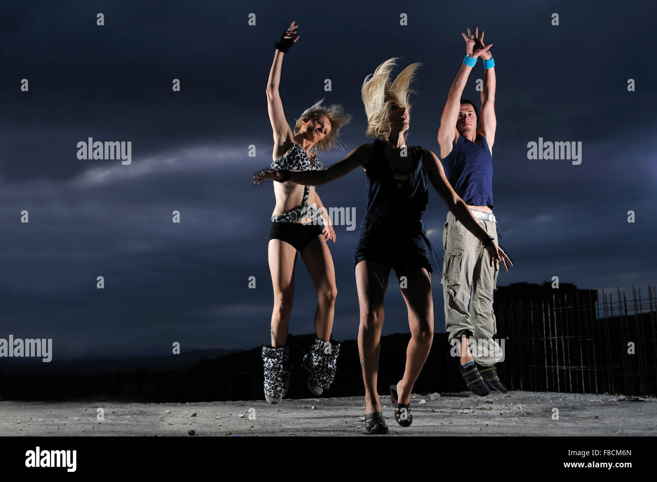 group of people jumping in air in night Stock Photo - Alamy