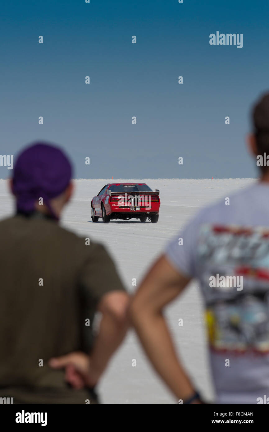 Unidentified men looking a hot rod riding in the background Stock Photo ...