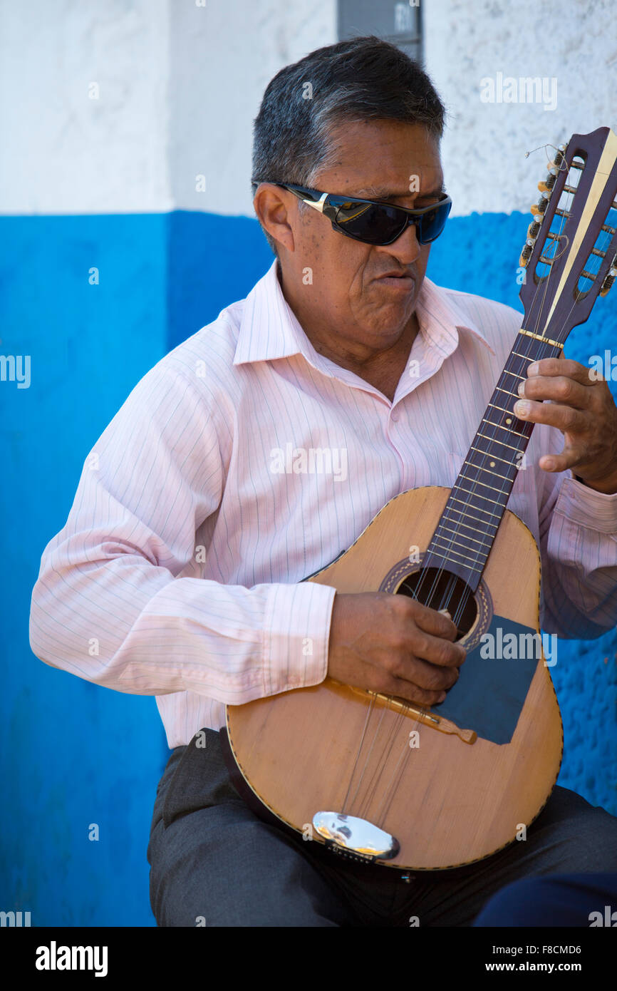Peruvian blind musician playing guitar outside, Trujillo Stock Photo ...