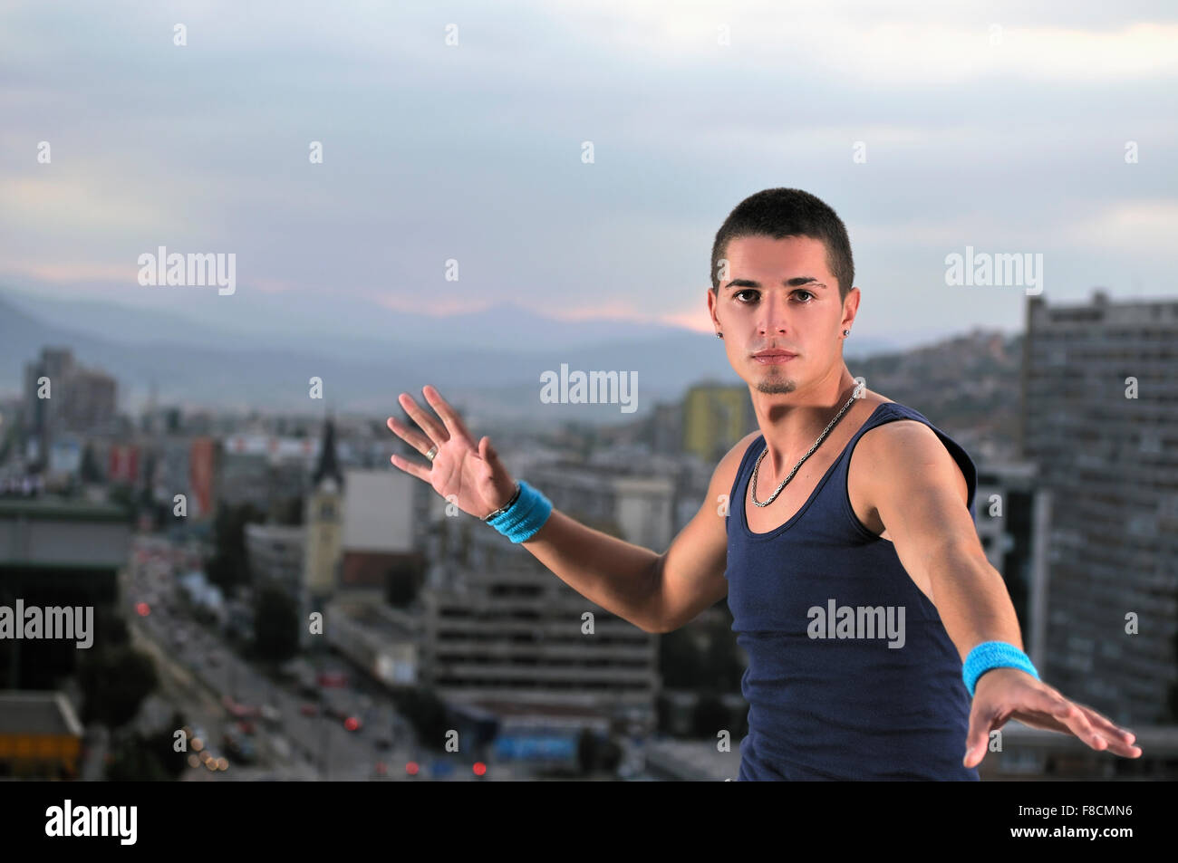 young man dancing and jumping on top of the building Stock Photo - Alamy